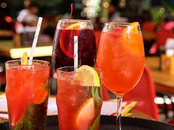 A rainbow of cocktails that proves drinking can indeed be a form of artistic expression. Each glass promises a different escape from reality.