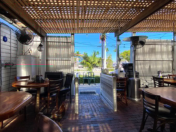 Sunlight streams through the open-air dining space, where ceiling fans keep the tropical breeze moving and vacation mode activated.