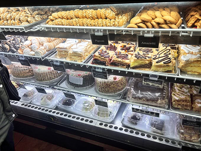 The pastry case displays its treasures like a museum of edible art, each shelf a different gallery of Italian sweet mastery.