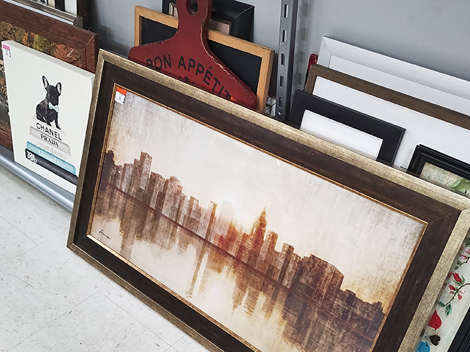 Framed artwork leans in casual clusters, including cityscape prints that could transform blank walls without the gallery price tag.