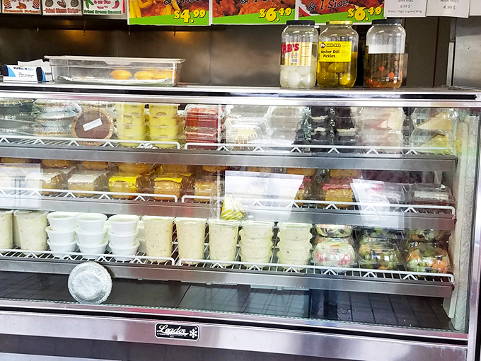 The display case of sides and extras&mdash;because no fried chicken feast is complete without the supporting cast of culinary characters.