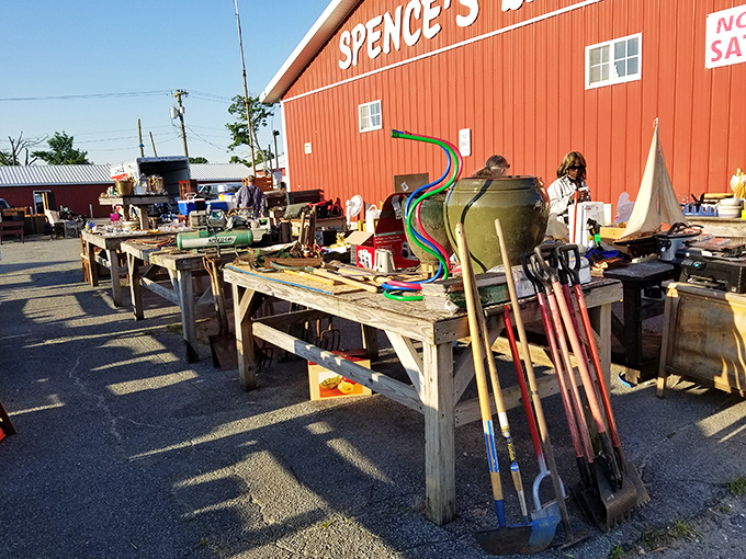 Garden tools stand at attention outside the barn&mdash;that green watering can has probably nurtured more successful gardens than most Instagram plant influencers.