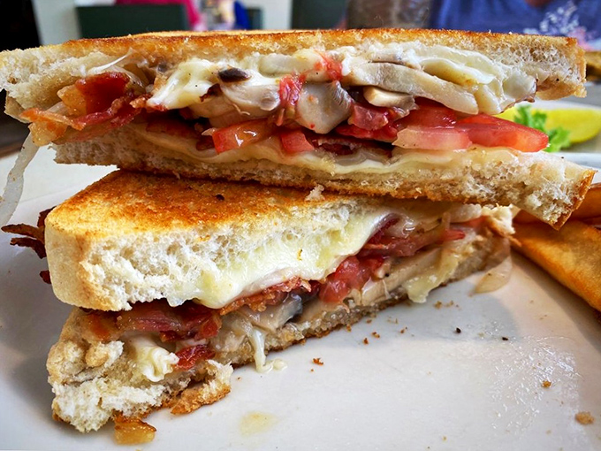 This isn't just a sandwich&mdash;it's a grilled cheese masterpiece with layers of melty goodness and fresh tomato that would make any childhood memory jealous. 