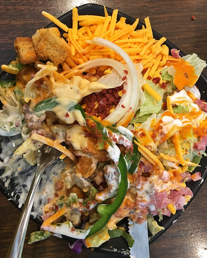 This isn't just a salad; it's a colorful celebration where vegetables, cheese, and bacon have achieved perfect harmony.