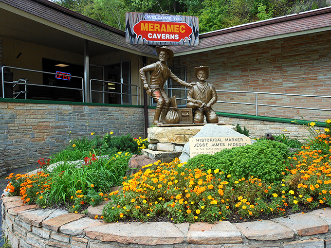 Jesse James and his companion stand frozen in bronze, eternally planning their next heist amid a garden that blooms with historical significance.