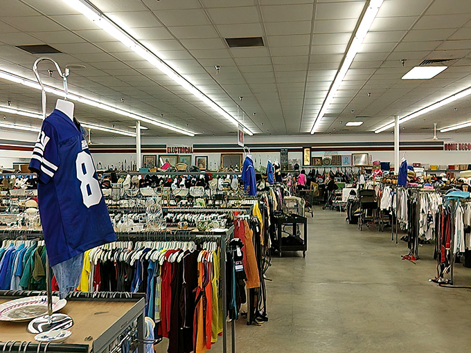 Sports memorabilia meets everyday fashion. That vintage jersey might have witnessed historic touchdowns before finding its way to this fluorescent-lit purgatory.