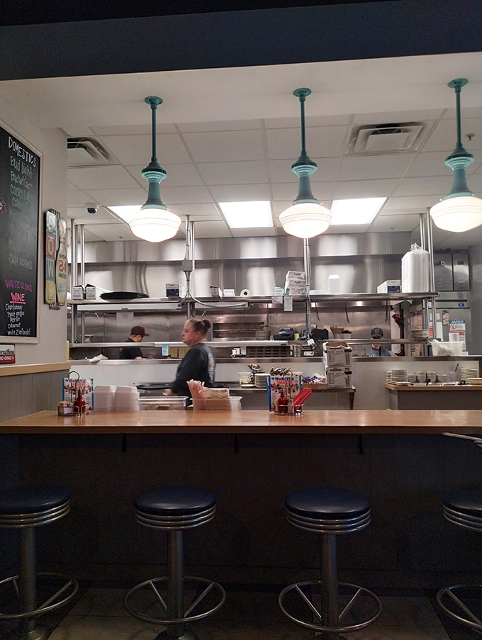 Counter seating: where solo diners become part of the Blue Ash family. Watch culinary magic happen while perched on these classic diner stools.