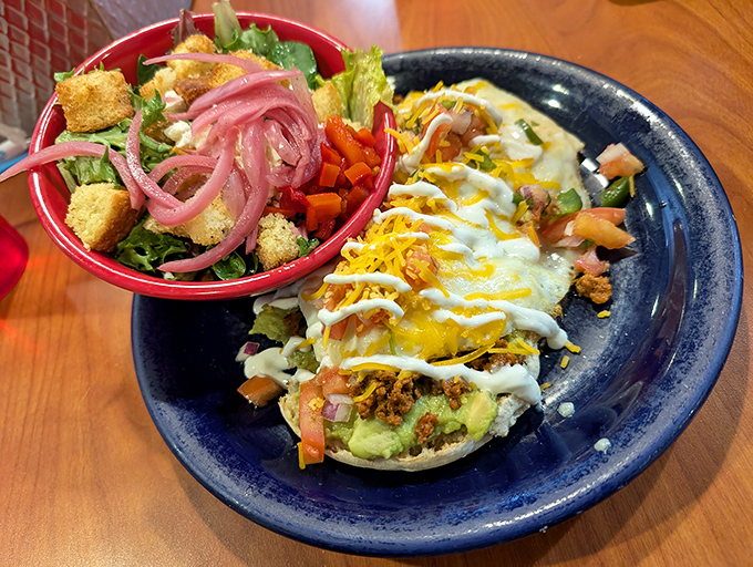 A loaded tostada that doesn't understand the concept of "holding back." Vibrant, colorful, and demanding to be photographed before it's devoured.