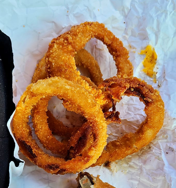 These aren't just onion rings; they're golden halos of crispy perfection that make you wonder why anyone bothers with lesser versions.