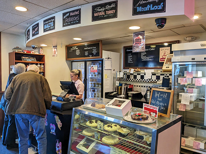The counter where magic happens. Those signs aren't just decoration&mdash;they're badges of honor earned through decades of perfecting comfort classics.