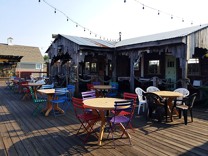 Colorful chairs dot the wooden deck like confetti, inviting you to enjoy your seafood feast with a side of fresh air.