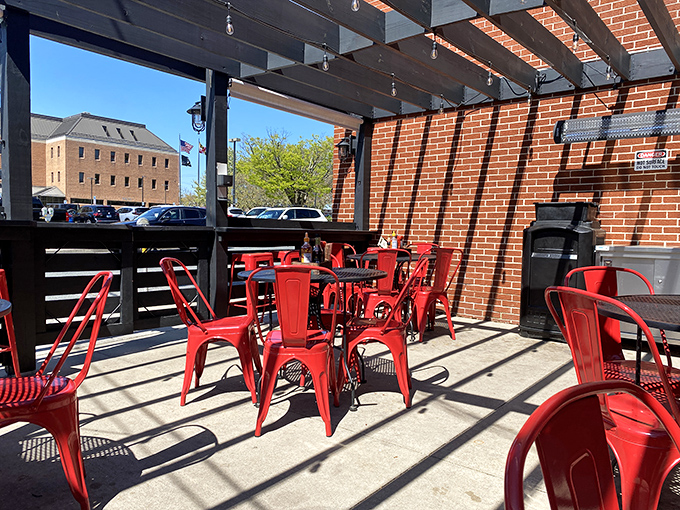 Red chairs under blue skies create the perfect stage for outdoor dining, where sandwiches taste even better with a side of sunshine.