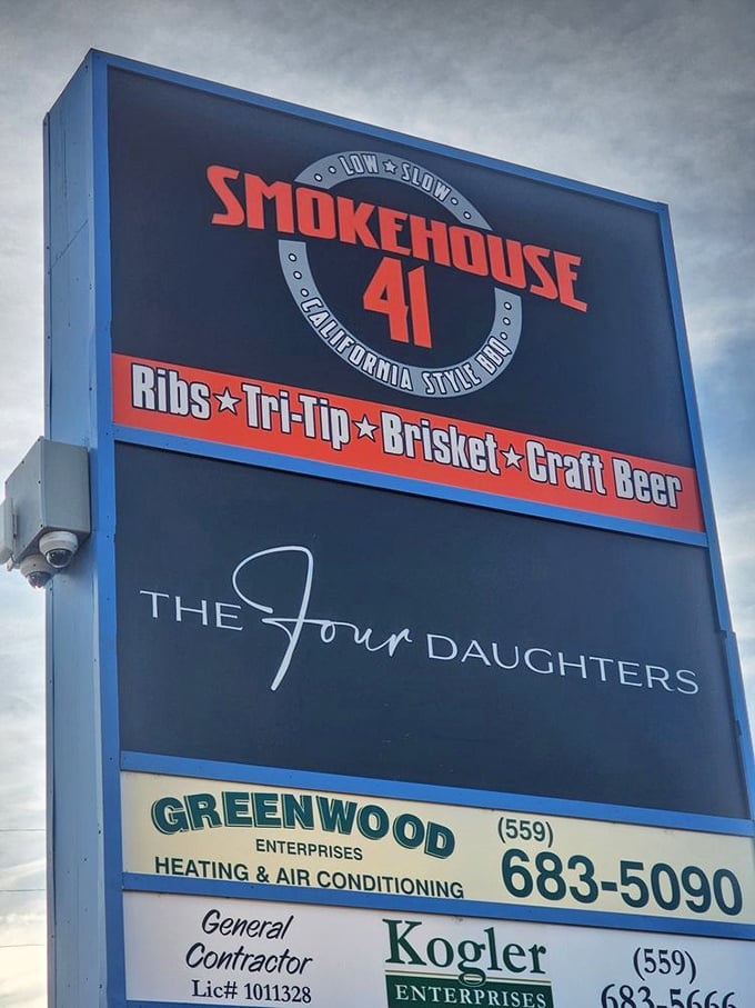 The roadside sign tells you exactly what matters: Ribs, Tri-Tip, Brisket, Craft Beer. Four pillars of a well-balanced barbecue lifestyle.