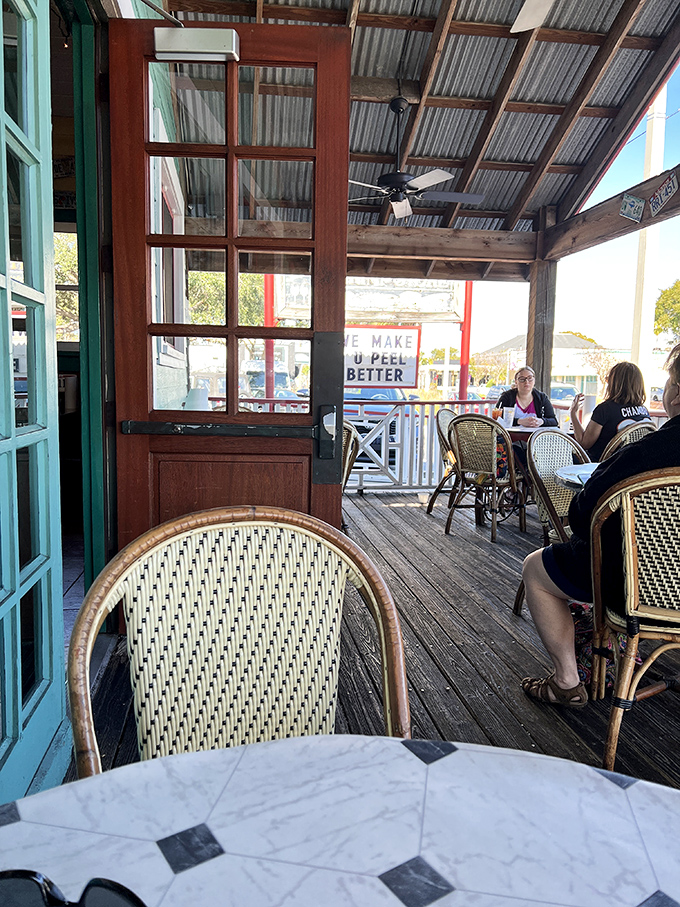 Woven chairs and wooden beams create a breezy patio space where the Florida air seasons every bite with a dash of sunshine.