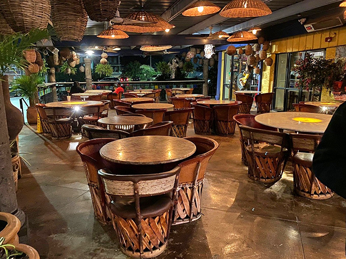 The patio seating area feels like dining in an artisan's courtyard, where woven basket lights cast the kind of glow that makes everyone look ten years younger.