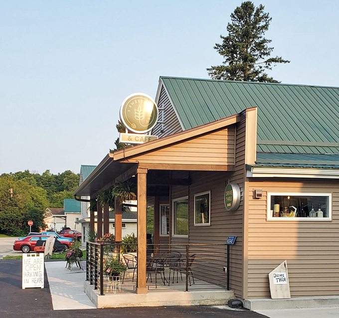 Small-town architecture with big personality. The distinctive green roof and welcoming porch signal that exceptional baked goods await within.