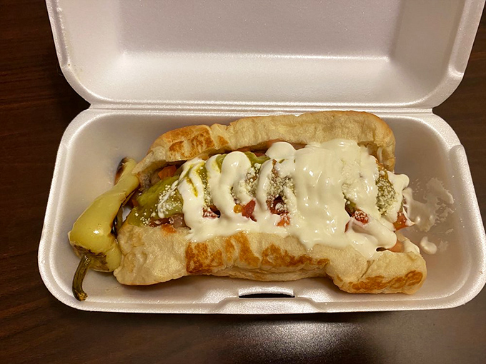 Styrofoam never held anything so noble. This hot dog's mayo drizzle is what Jackson Pollock would create if he worked in condiments.