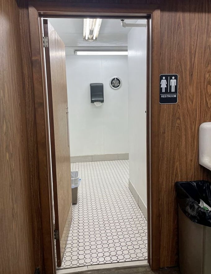 Even the restroom maintains period charm with classic hexagonal tile. A brief respite before diving back into the hunt.