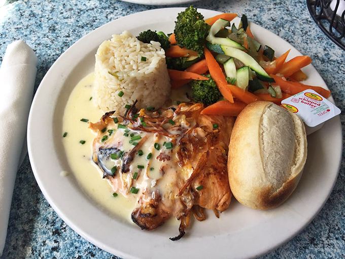 Salmon that looks like it's been kissed by flame, nestled beside vibrant vegetables that didn't come from the freezer section.