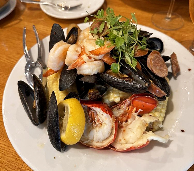 This seafood medley isn't just a dish&mdash;it's a maritime celebration where mussels, shrimp, and lobster gather on a bed of corn like a delicious underwater reunion.