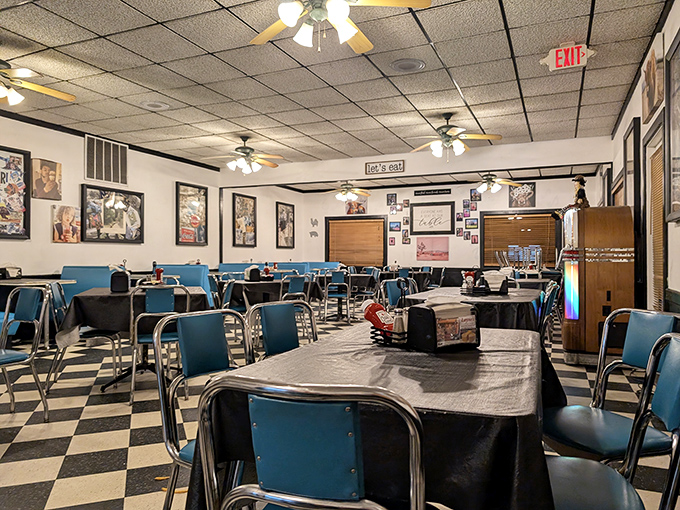 Empty tables that won't stay that way for long. The blue chairs and checkerboard floor create the perfect stage for comfort food theater.