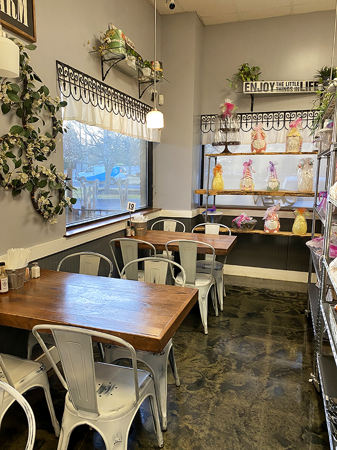 A cozy corner where "Enjoy the little things in life" isn't just wall decor—it's the mission statement executed in wooden tables and greenery.