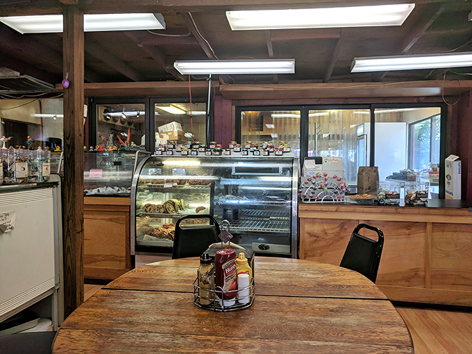 Simple wooden tables and chairs say, "Sit down, stay awhile, and contemplate ordering seconds." The bakery counter beckons in the background.