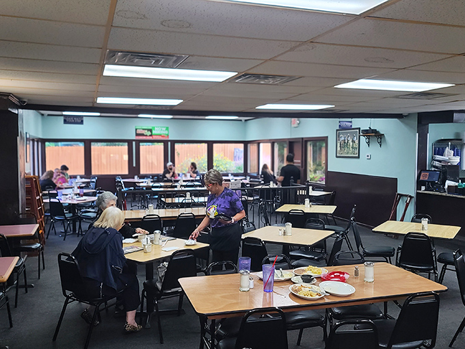 The dining room where strangers become neighbors over plates of enchiladas. Notice the absence of people staring at phones—they're too busy eating.