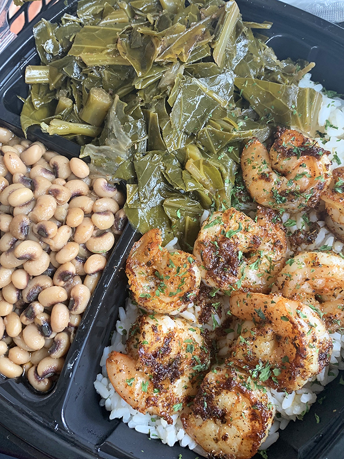 Seasoned shrimp resting on a bed of rice, with collards and black-eyed peas standing guard. This isn't a meal; it's a Southern trinity.