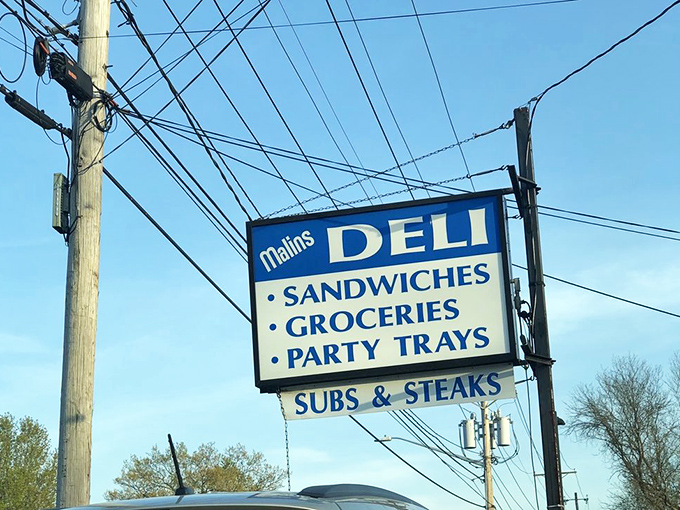 The roadside beacon that's guided hungry travelers for generations &ndash; Malin's sign promises sandwiches, groceries, and party trays with equal conviction.