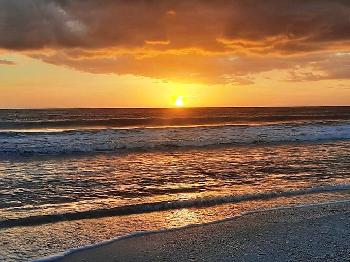 The sun takes its final bow of the day, painting the Gulf waters with a palette that would make even Monet jealous.