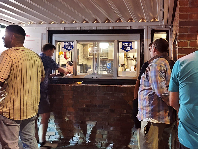 Late-night salvation comes through this window, where hungry night owls and early birds cross paths in pursuit of griddled perfection.