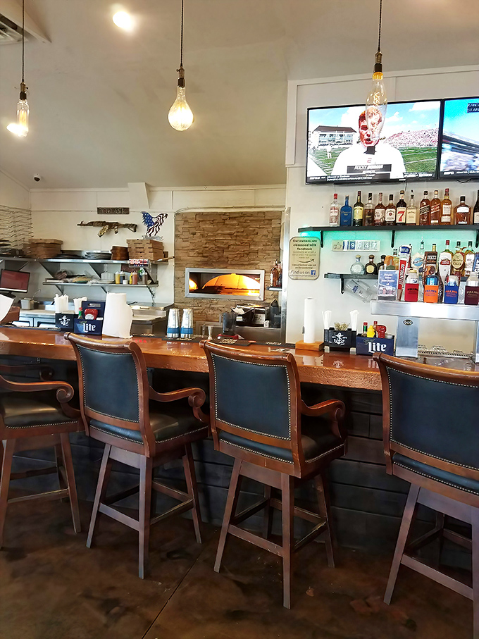 The bar area combines rustic wood with leather chairs – like a fisherman's lodge that went to finishing school but kept its soul.