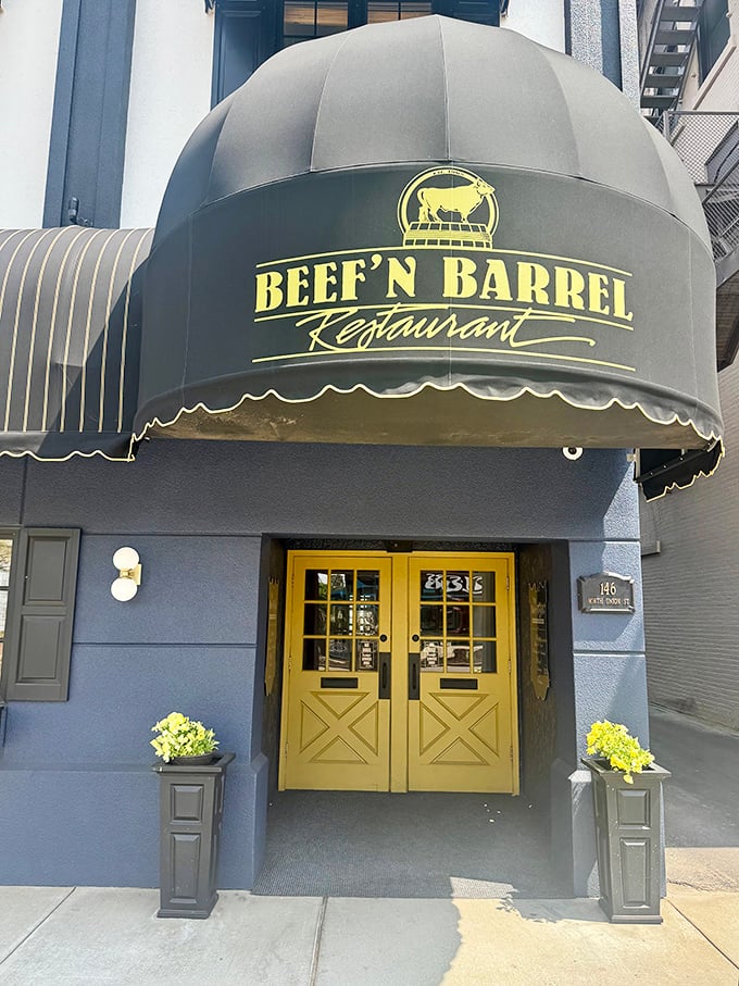 Beef-N-Barrel's distinctive dome awning and yellow doors make a cheerful first impression. Olean's steak landmark stands proud.