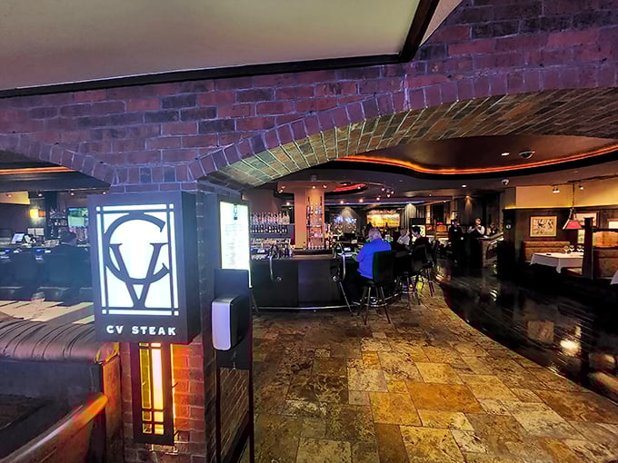 Brick, wood, and that illuminated CV logo create a steakhouse atmosphere that feels both timeless and perfectly of the moment.