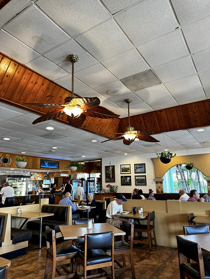 Palm-frond ceiling fans and wood-paneled warmth create that "everybody knows your name" vibe that chain restaurants spend millions trying to replicate.