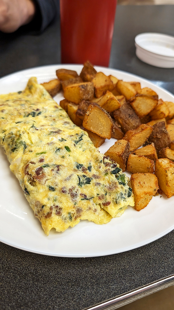 This isn't just an omelet&mdash;it's a vegetable-studded canvas of breakfast artistry paired with potatoes that achieved the perfect crisp-tender balance.