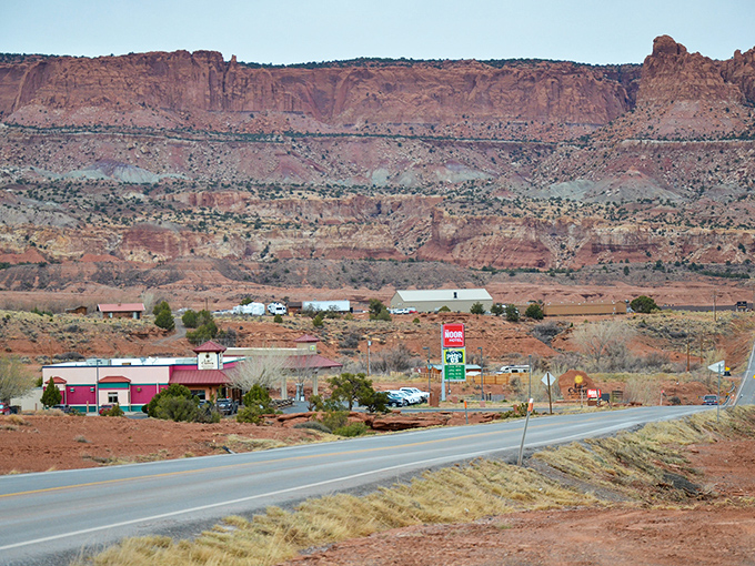 Highway meets heritage in this roadside snapshot of Torrey. The town nestles against red rock walls like it's being embraced by the landscape itself.
