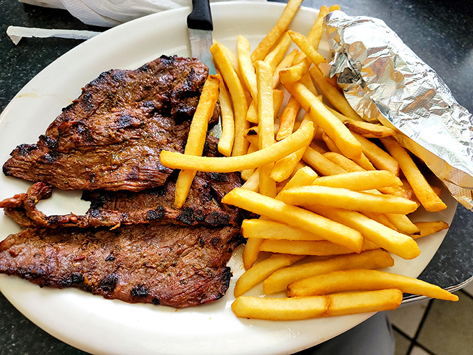 Perfectly grilled asado with golden fries&mdash;sometimes the simplest dishes reveal a kitchen's true talent.