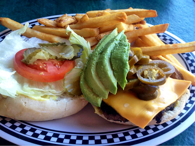 Behold the California interpretation of burger perfection: melted cheese, fresh vegetables, and avocado slices thick enough to make a millennial weep with joy.