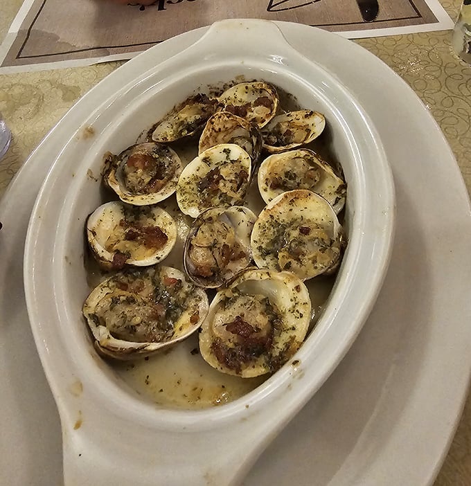 Baked clams swimming in buttery, garlicky goodness &ndash; the kind of appetizer that makes you contemplate ordering a second round.