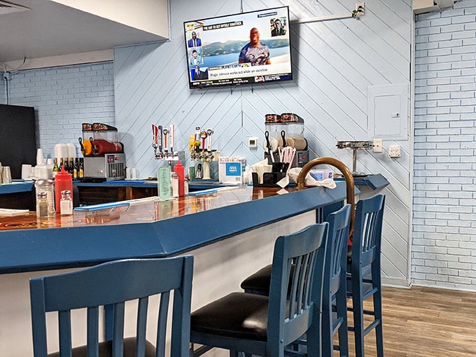 The blue-accented bar area offers counter seating for solo diners or those who appreciate watching breakfast magic happen in real time.