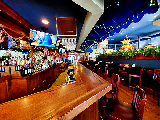 The gleaming wooden bar invites both serious conversations and lighthearted banter &ndash; the beating heart of Sycamore Grille's community spirit.