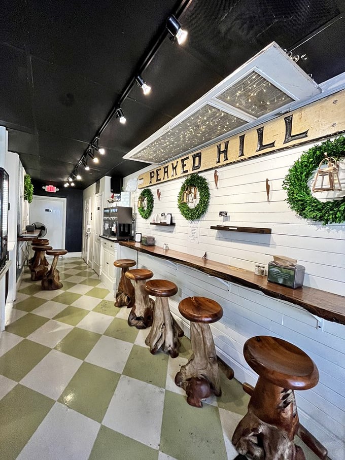 Rustic wooden stools with tree-trunk bases line the "Peaked Hill" counter area, bringing a touch of whimsical forest charm to this temple of fried potatoes.
