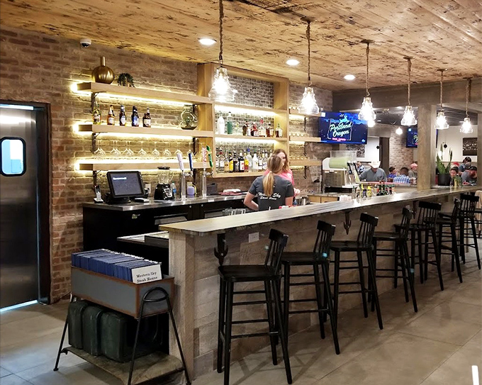 The bar seating offers front-row views of mixology magic in a space where rustic charm meets modern comfort.