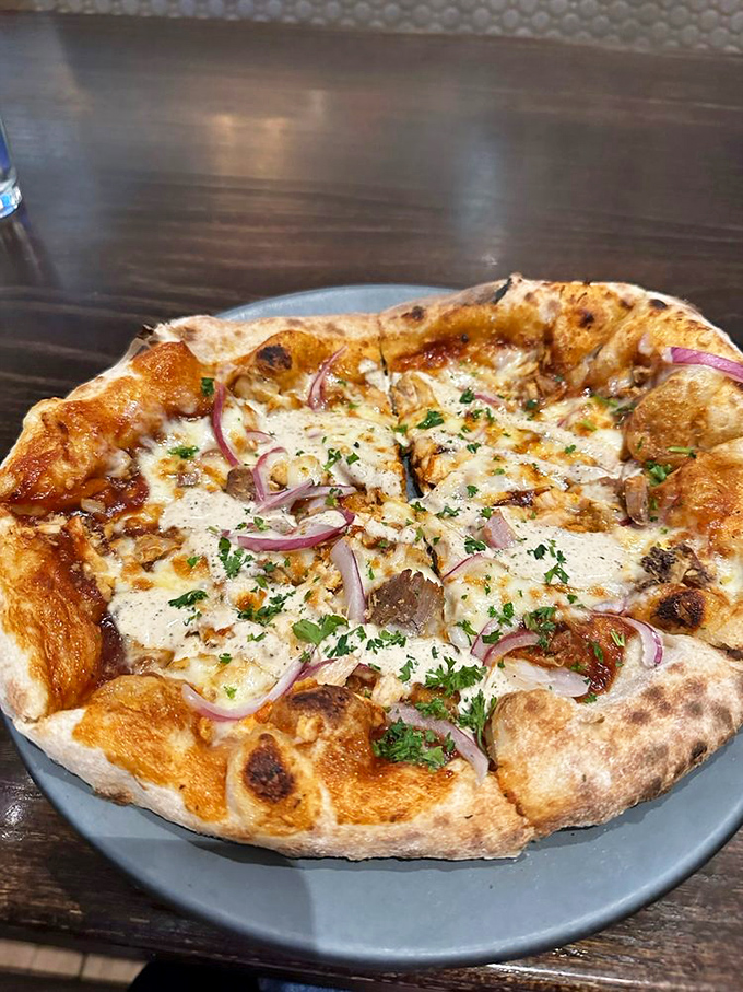 Wood-fired pizza with that perfect char: The crust has just the right amount of chew, like a good conversation that lingers pleasantly.