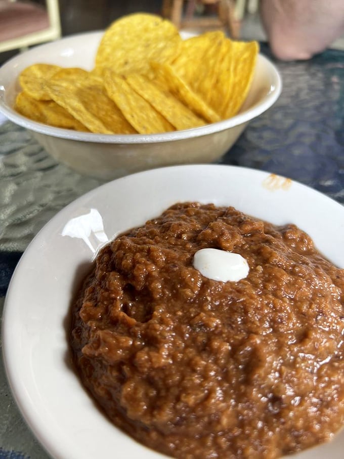 This isn't just bean dip&mdash;it's a warm, spiced revelation with homemade chips. The kind of starter that makes you reconsider your entire relationship with beans.