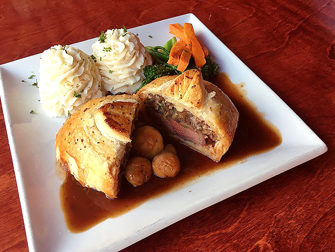 Beef Wellington cut open to reveal its rosy secret &ndash; a dish so perfectly executed it would make Gordon Ramsay drop his famous scowl for a smile.
