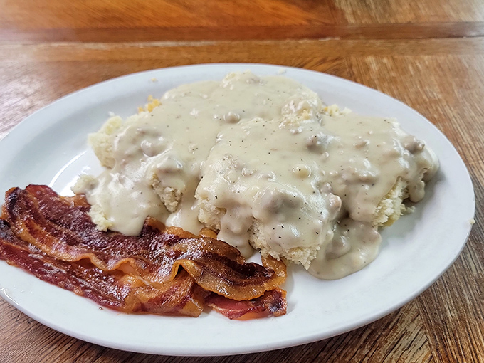Biscuits and gravy with a side of bacon&mdash;a plate that says "You won't need dinner" in the most delicious way possible.