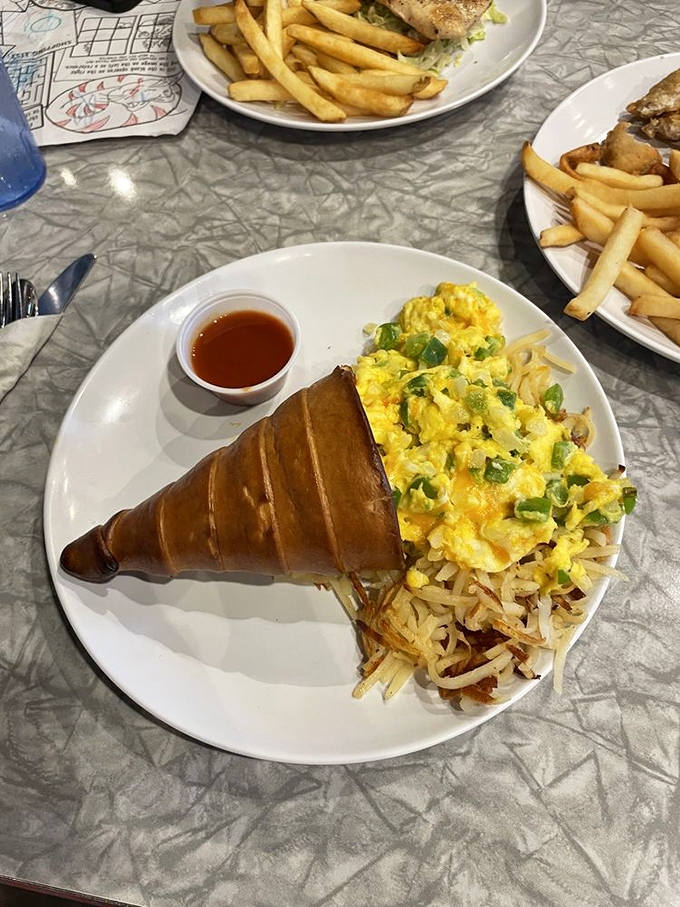 The breakfast "conewich" &ndash; proof that innovation isn't dead in diners, with eggs and hash browns nestled in a croissant cone of genius.